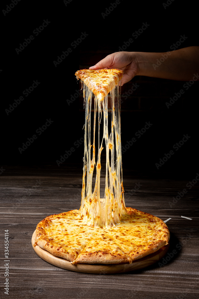 Stretched cheese pizza Stock Photo | Adobe Stock