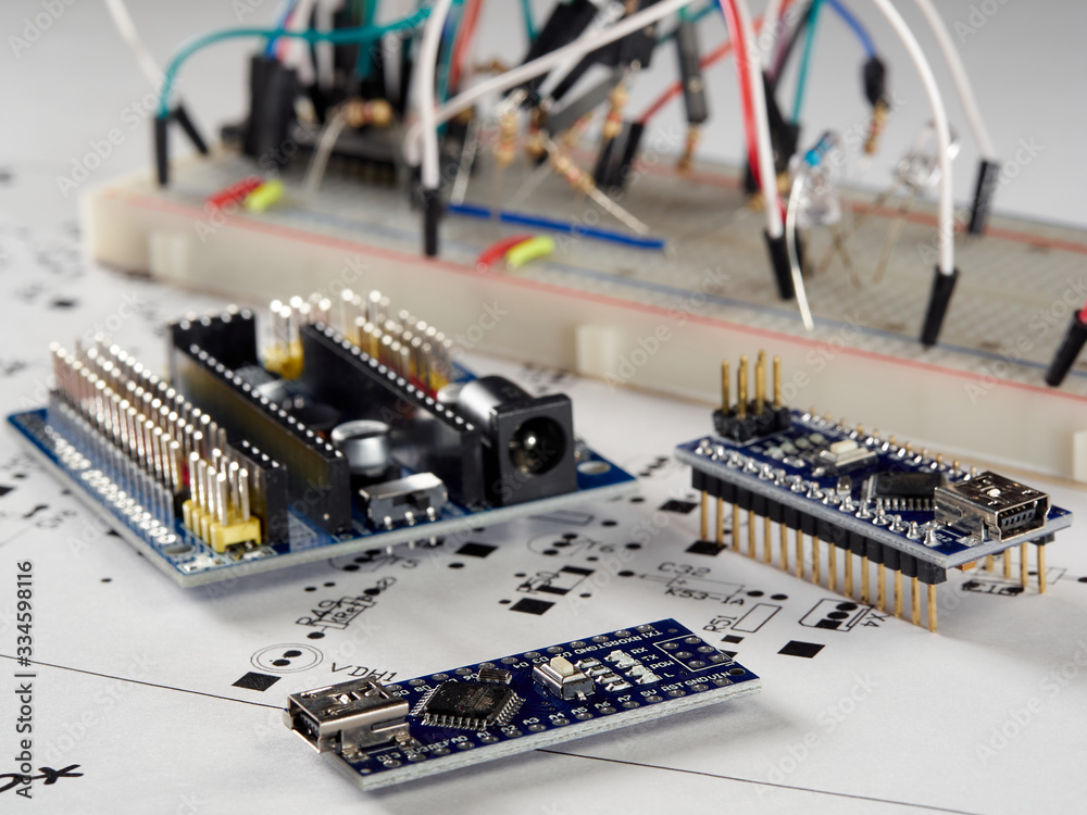 Arduino and programmers with peripherals and expansion boards lie on a ...