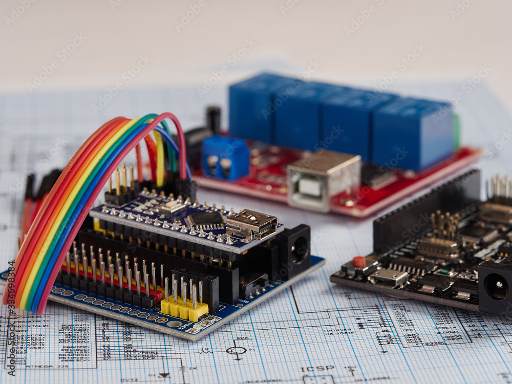 Arduino and programmers with peripherals and expansion boards lie on a ...