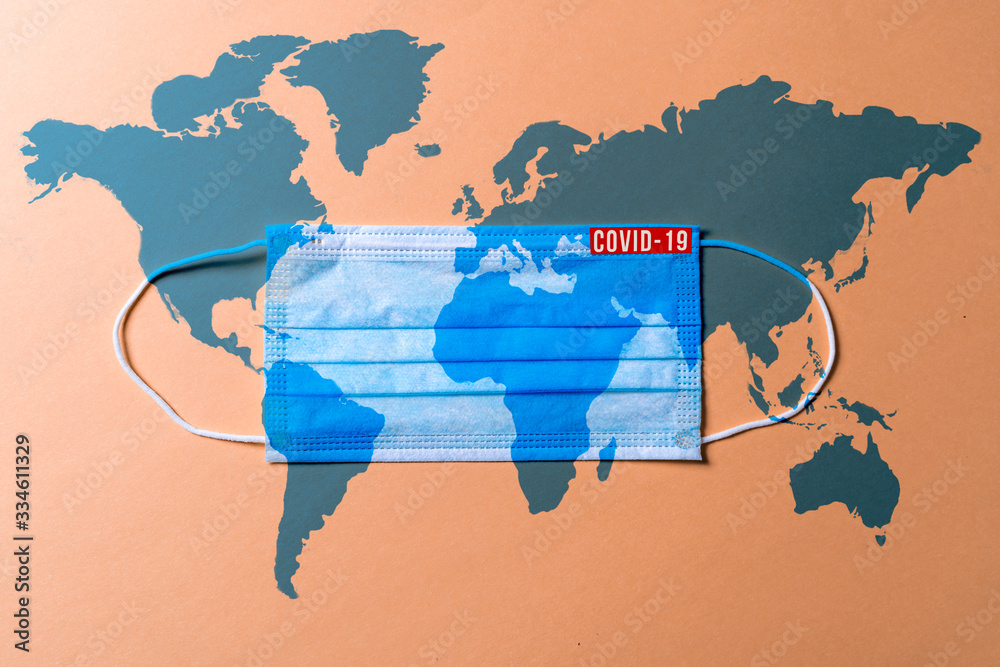 Covid-19. Surgical mask with a map of the world; Concept of global ...