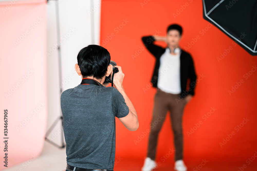 back view of male asian professional photographer taking picture of ...