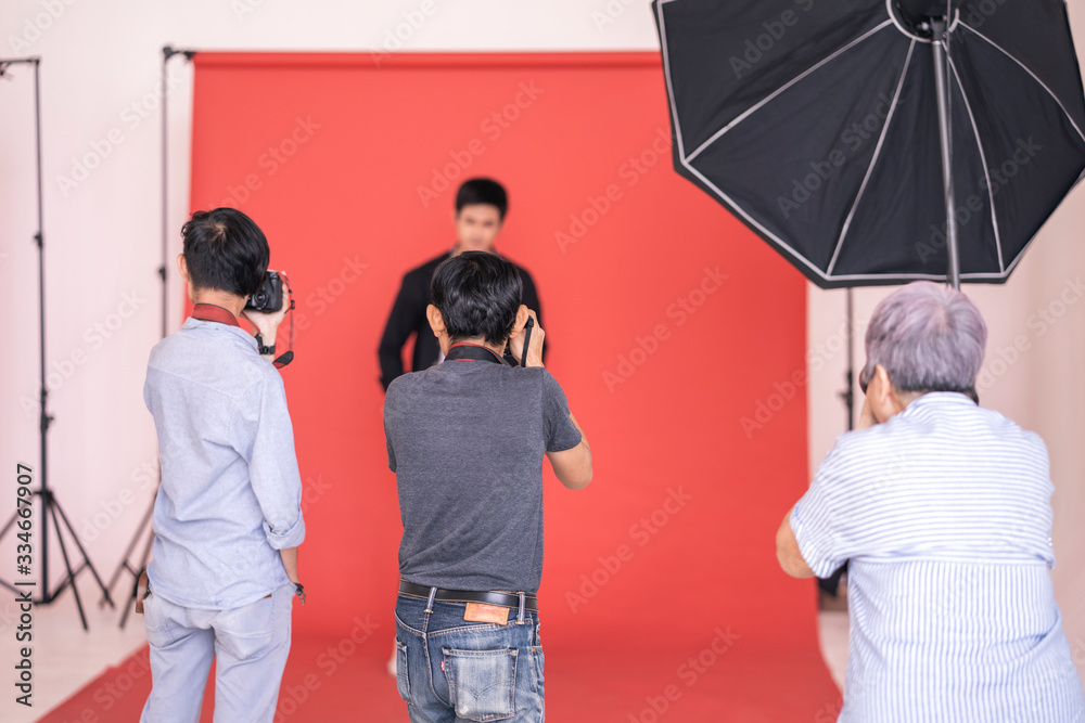 back view of male asian professional photographer taking picture of ...