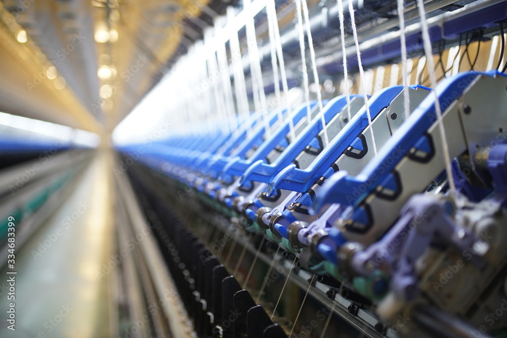 inside a textile factory, detailed image of yarn production and fabric ...