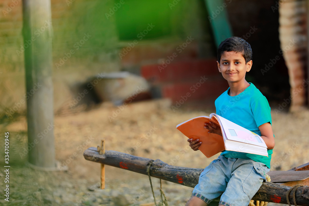 Cute indian child studying at home Stock Photo | Adobe Stock