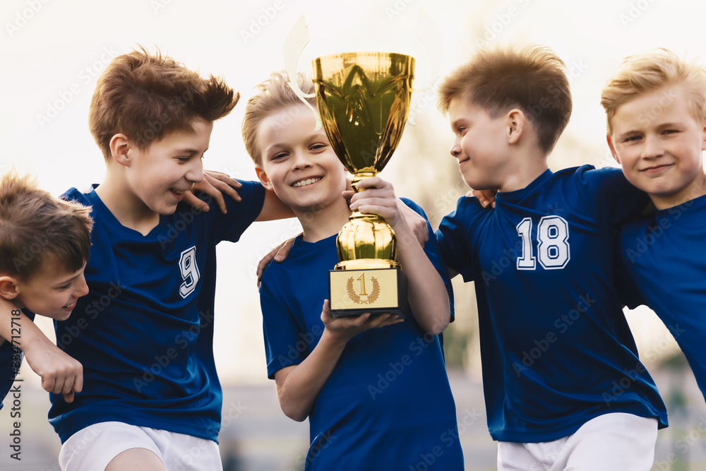 Children winning soccer tournament. Group of happy boys holding golden ...