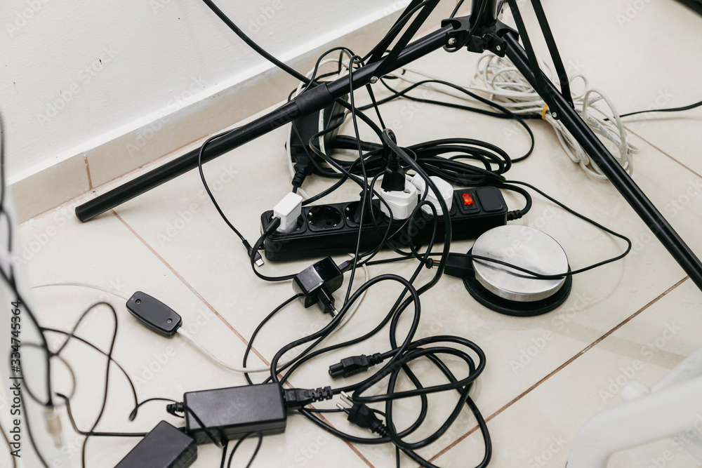 tangled wires of sockets on the floor in the office Stock Photo | Adobe ...