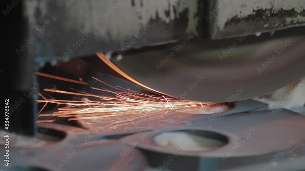 Metal grinding machine during grinding out the metal detail in factory ...