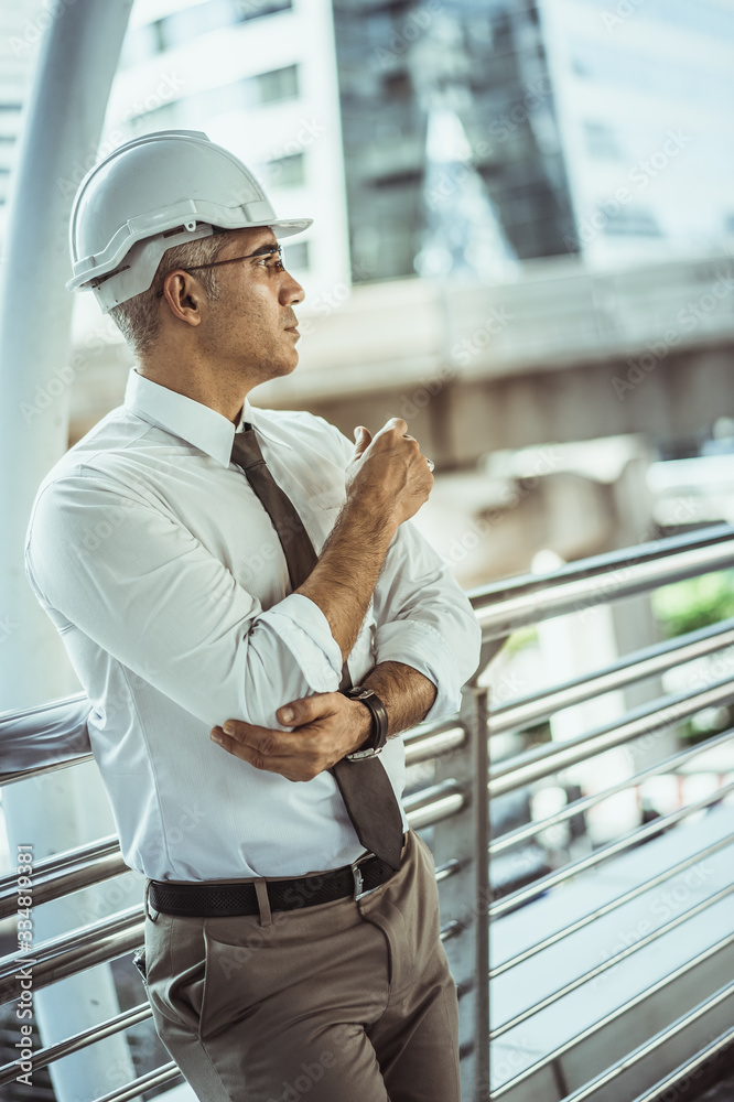 Business man, civil engineer wear a white safety helmet smiling and ...