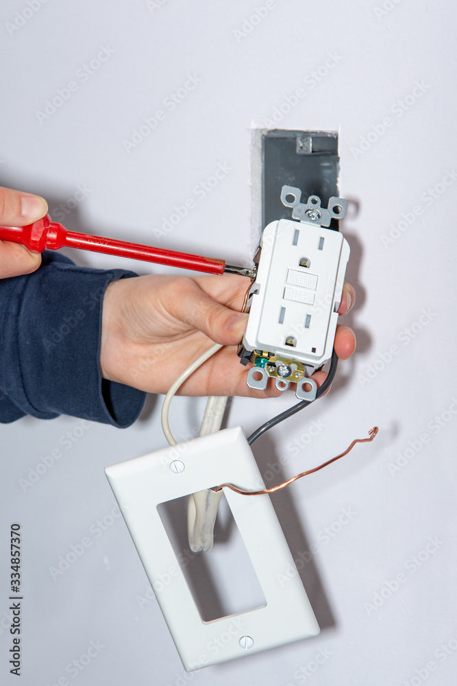 Installation of a socket with a fuse in a drywall Stock Photo | Adobe Stock