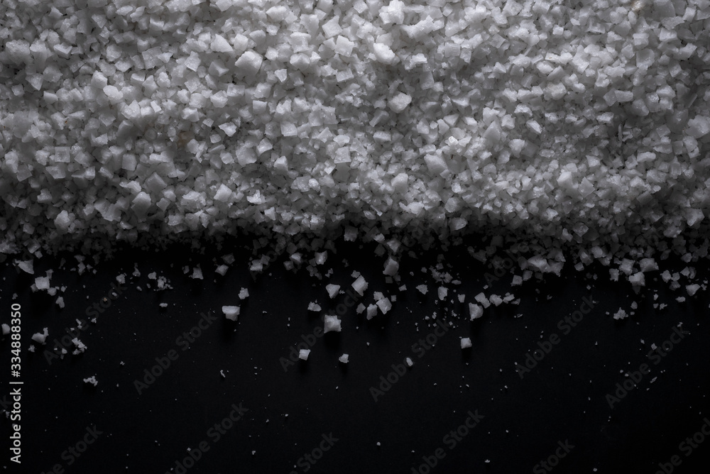 sea salt black Background of grains of salt crystals production. Heap ...