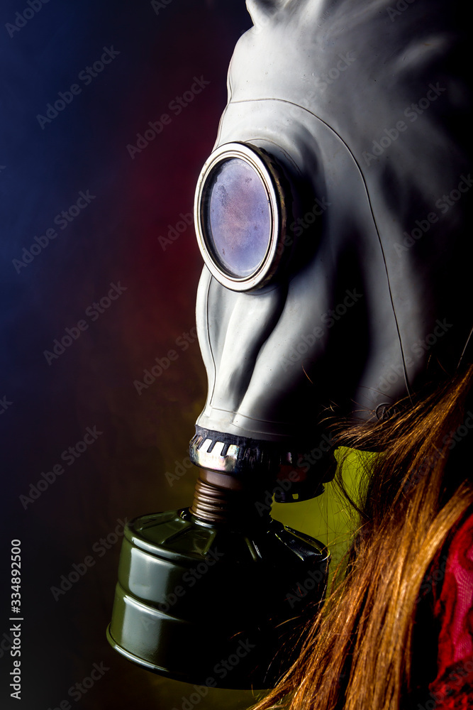girl in red dress wearing a gas mask sits in smoke with red blue and ...