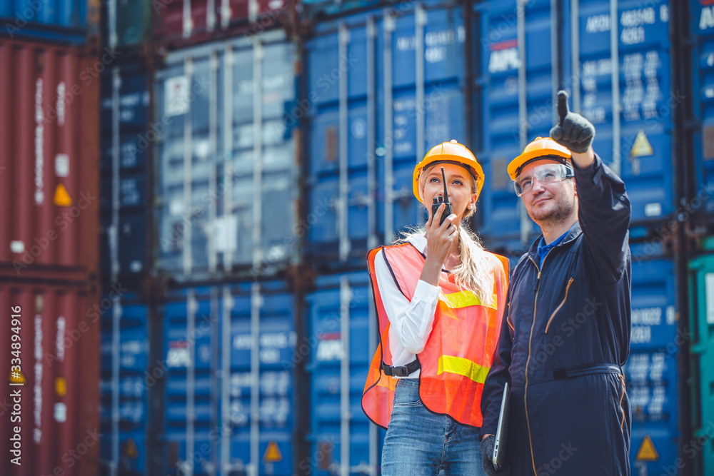 logistic worker man and woman working team with radio control loading ...