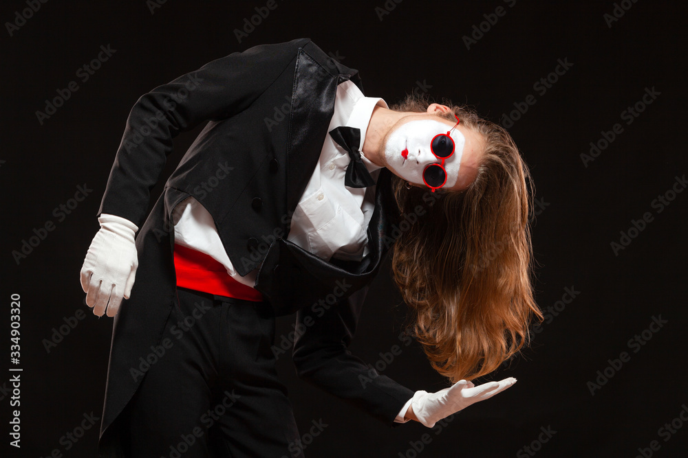 Portrait of male mime artist performing, isolated on black background ...