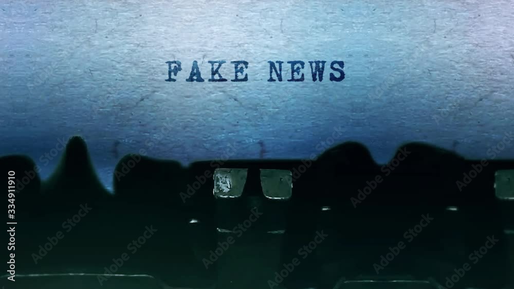 Fake News Word closeup Being Typing and Centered on a Sheet of paper on ...