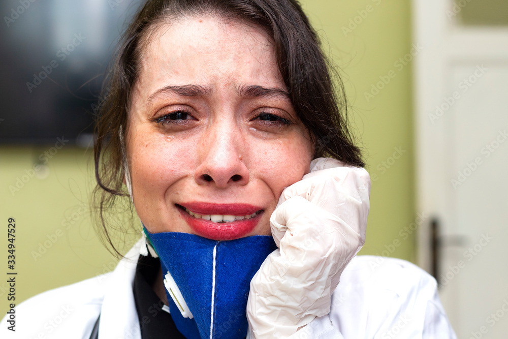 woman with beautiful eye and wearing blue mask and cries, in horror ...
