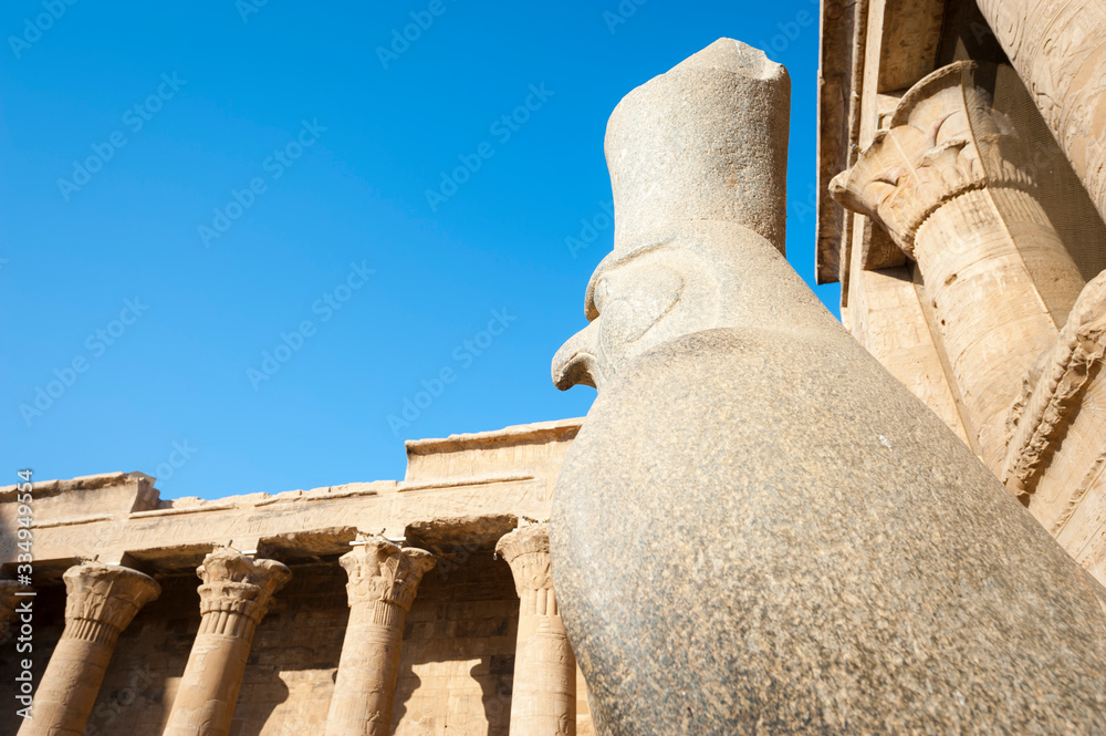 Portrait of ancient Egyptian falcon-god Horus looking stern in front of ...