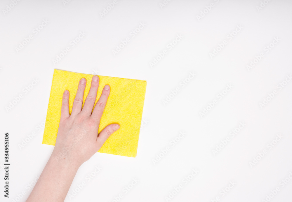 Part of the hand with a yellow cloth for dusting and removing dirt ...