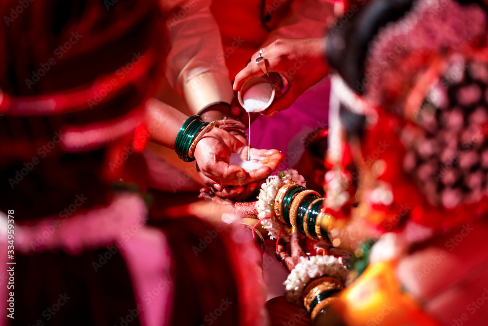indian wedding traditional style milk pouring celebration closeup ...