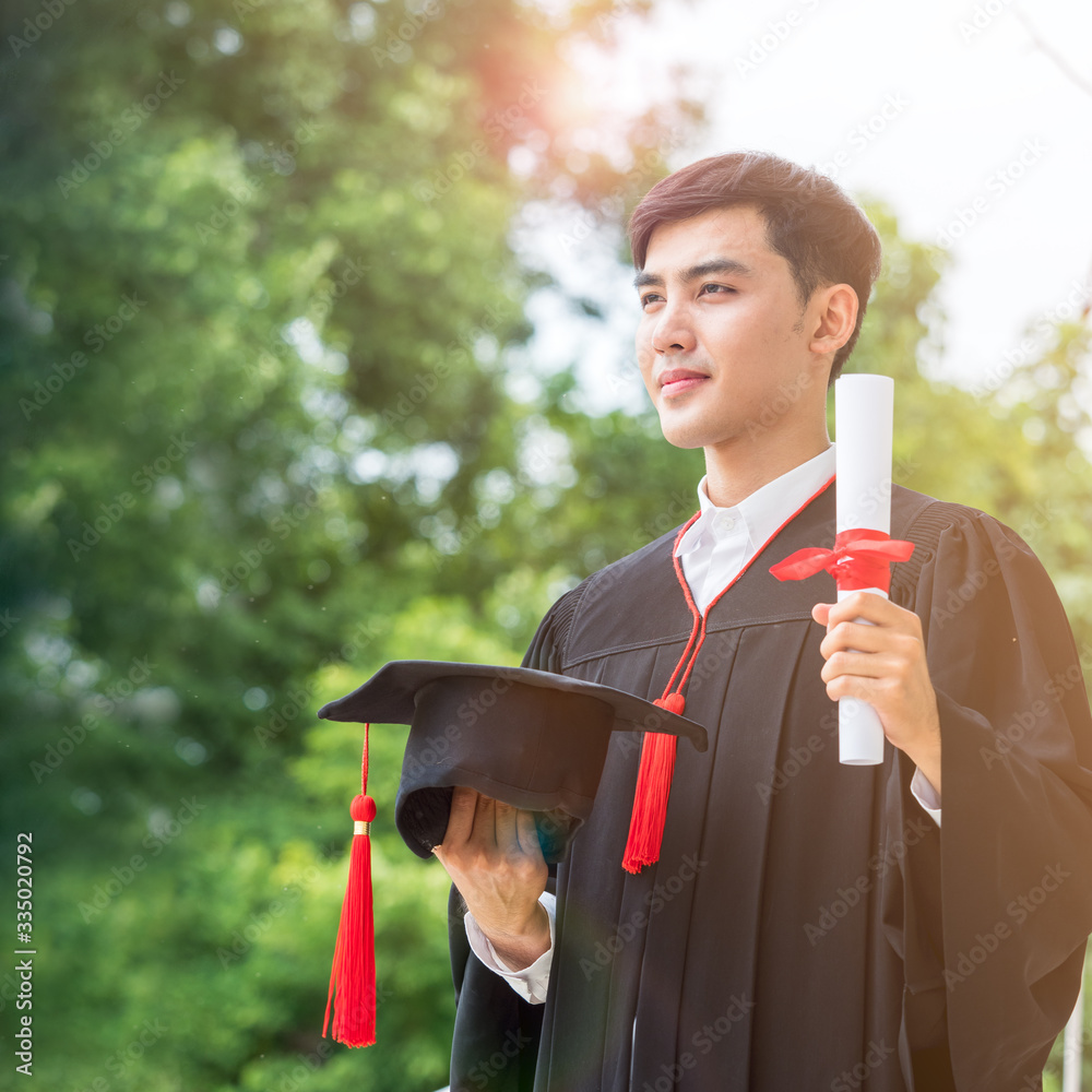 Square image of young Asian man looking ahead with pride, wearing ...