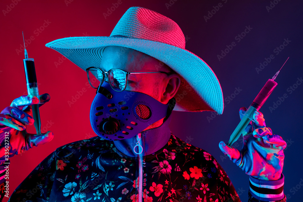 Stylish man wearing medical respirator mas, glasses, hat and gloves and ...