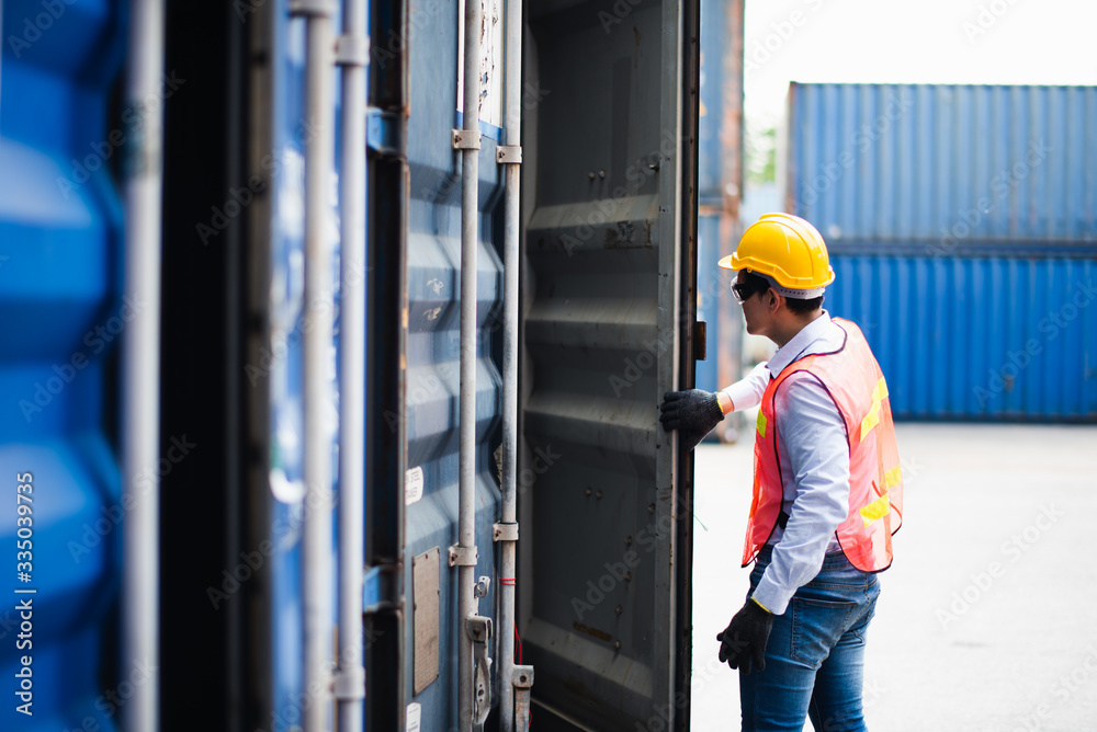Young Asian man worker foreman open the door of shipping Containers at ...