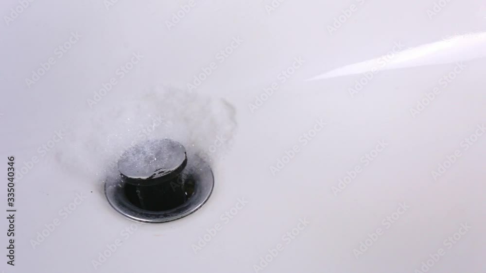 Foam in water drain hole in a wash basin disappearing time lapse Stock ...
