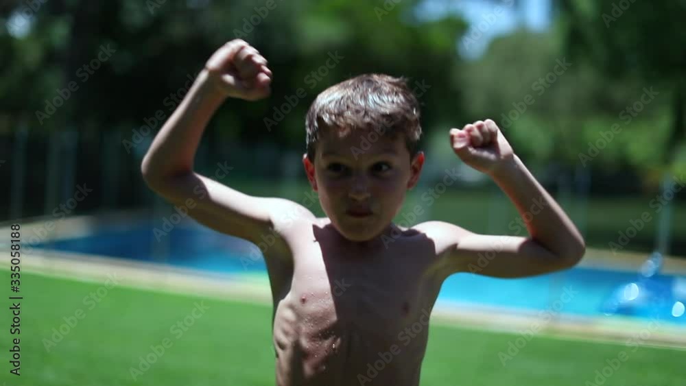 Child boy raising arms in the air in celebration. Kid celebrating ...