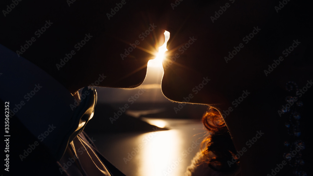 sun rays between the faces of the newlyweds. kiss on the nature. Stock ...