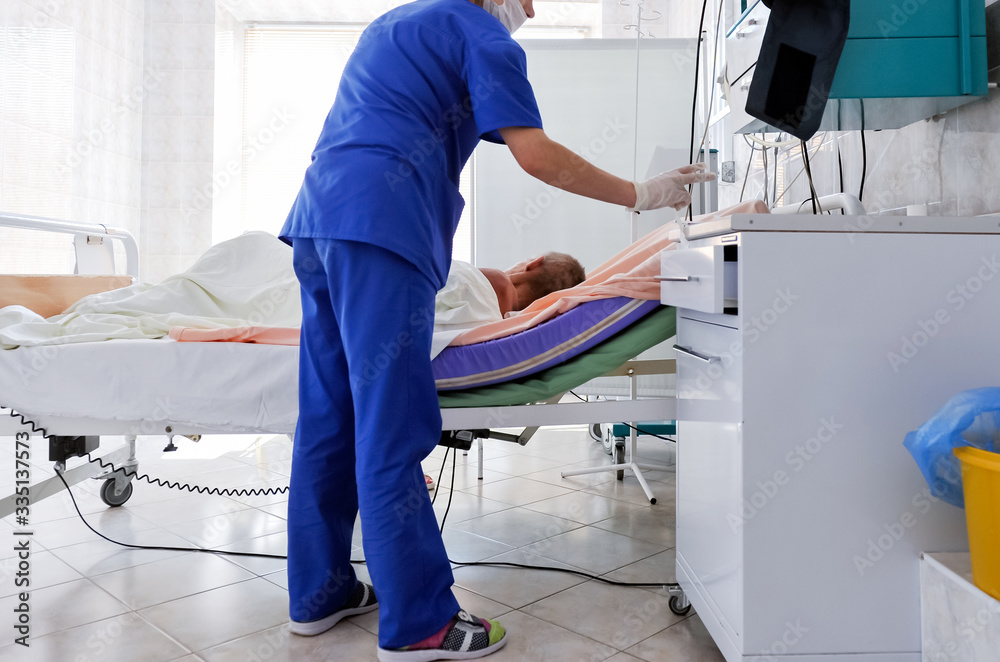 Emergency care in a hospital, safely dying patient. A man lies on a bed ...