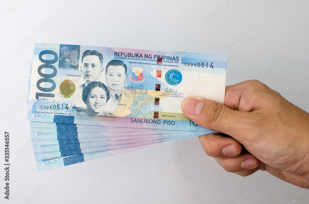 One thousand Philippine peso held by the fingers Stock Photo | Adobe Stock