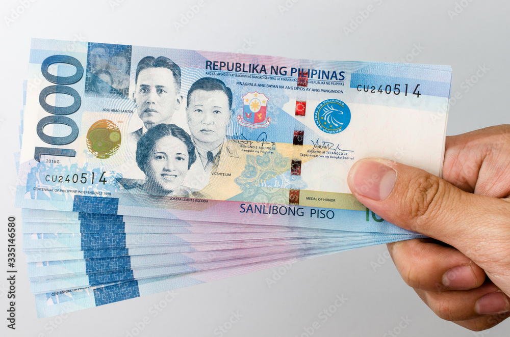 One thousand Philippine peso held by the hand Stock Photo | Adobe Stock