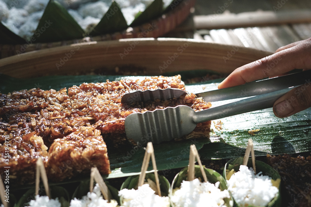 Sweet traditional snack or street food made by brown sugar and grated ...