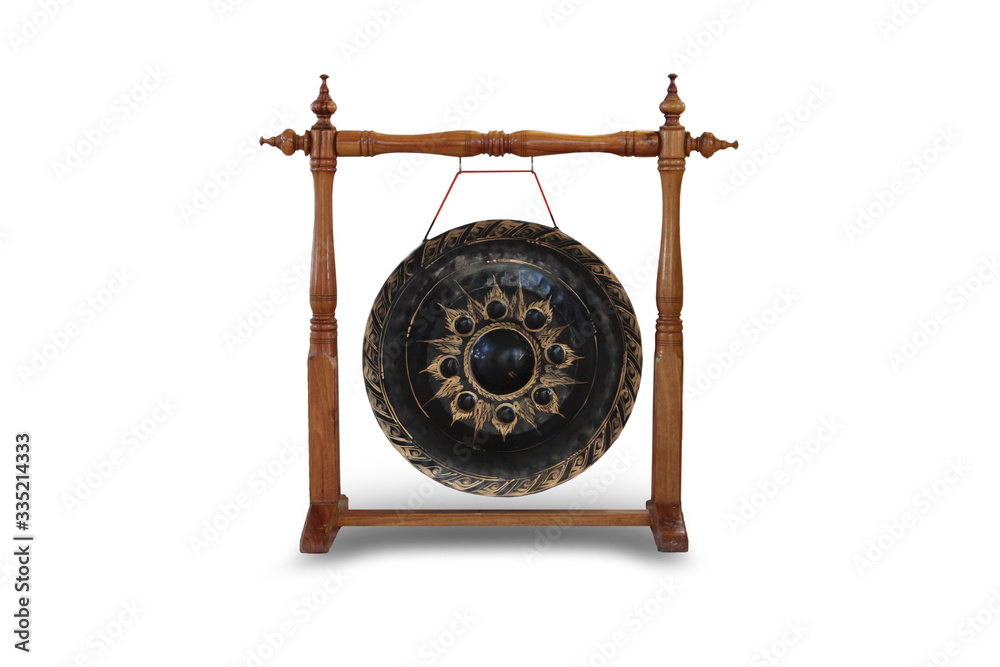 Thai gongs resting on a Thai style wooden stand on isolated white ...