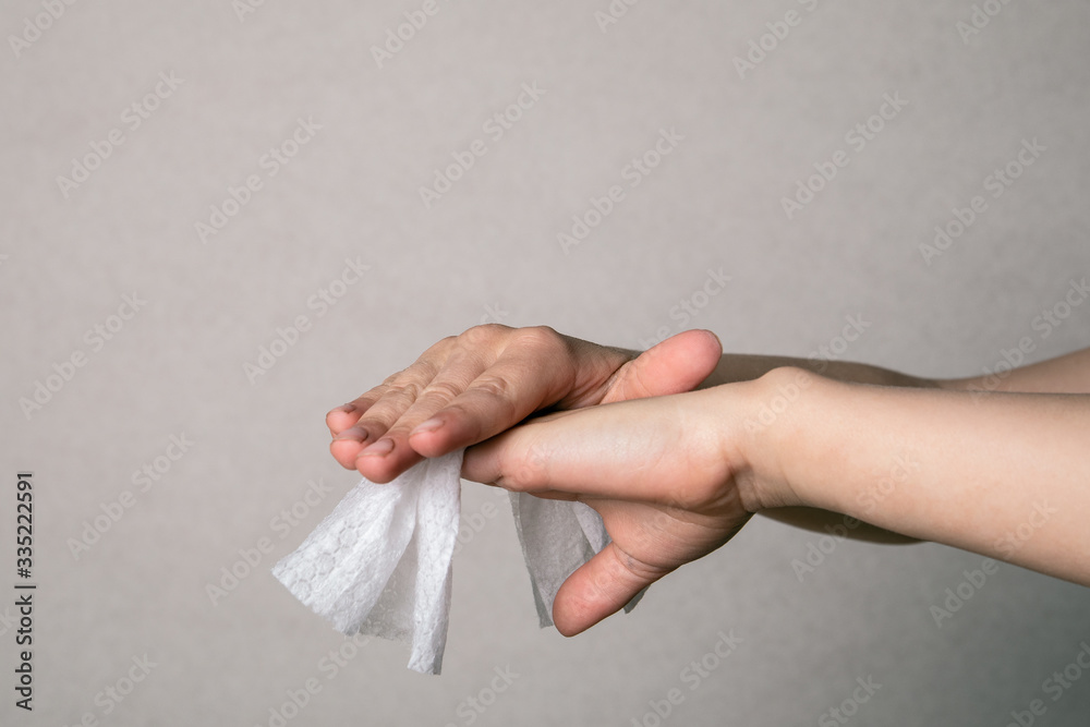 Child cleaning hands with antibacterial tissue. Personal hygiene and ...