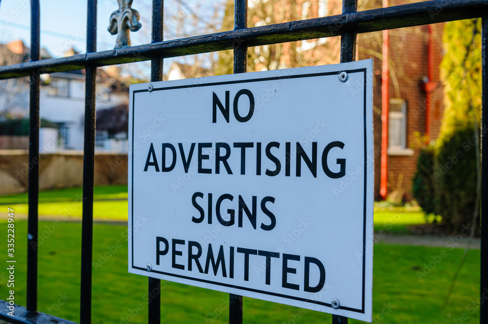 Sign on a fence warning that advertising signs are not permitted Stock ...