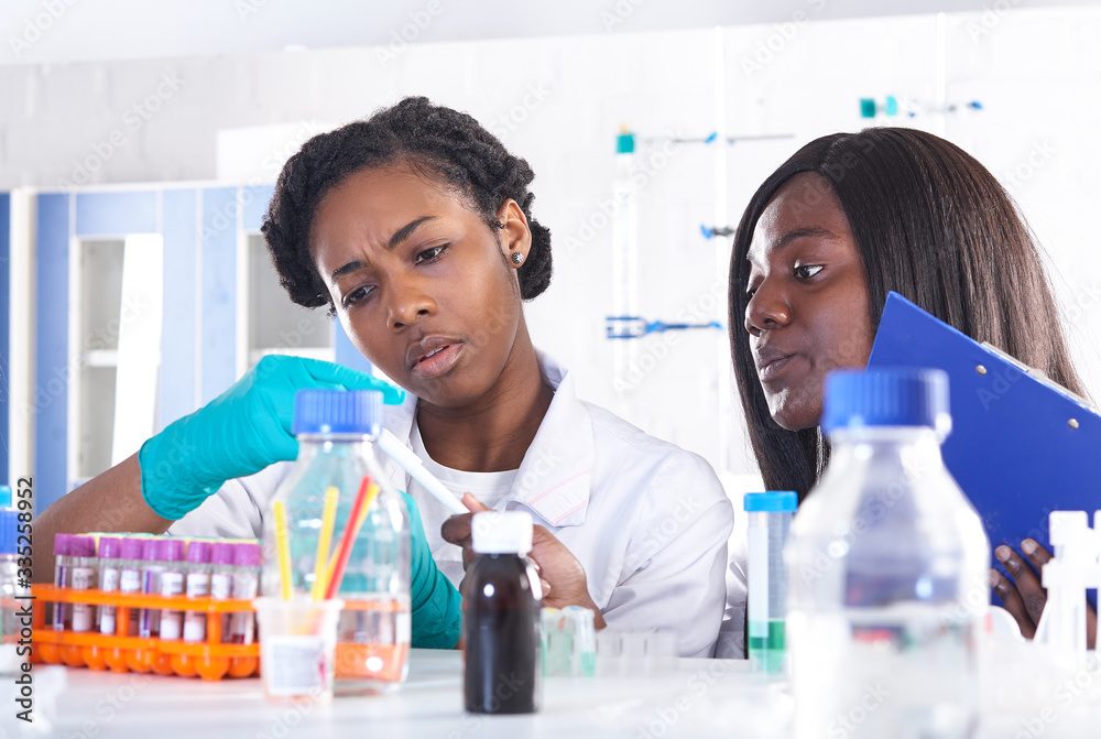 Female African tech women do pcr testing on patients samples in test ...