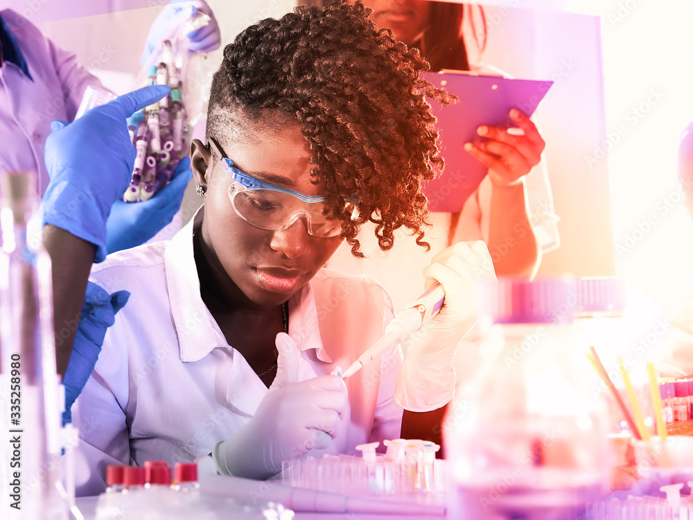 Female African medical students, young graduates in research laboratory ...