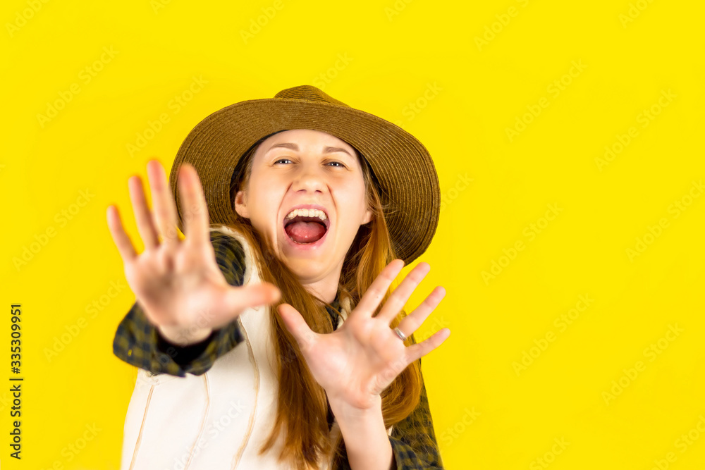 The portrait of a happy brown-haired woman makes a gesture with her ...