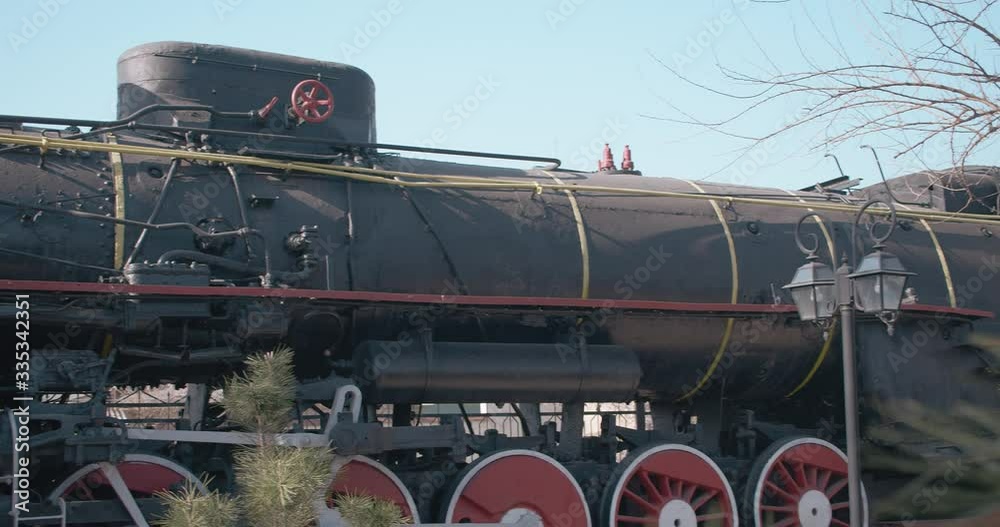 Unique black color steam train with a red wheels. A steam locomotive ...