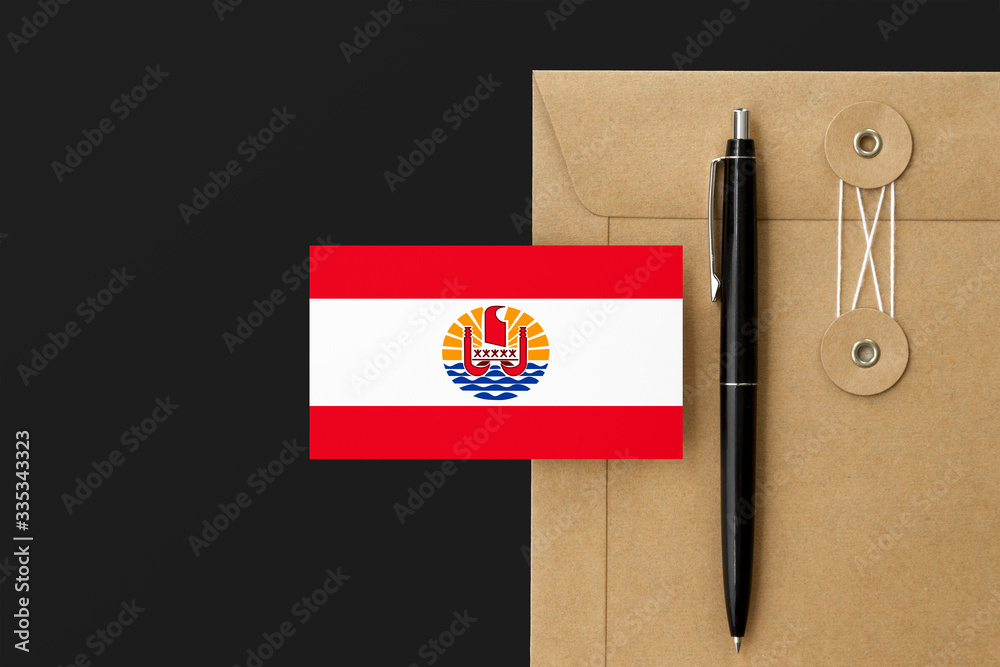 French Polynesia flag on craft envelope letter and black pen background ...