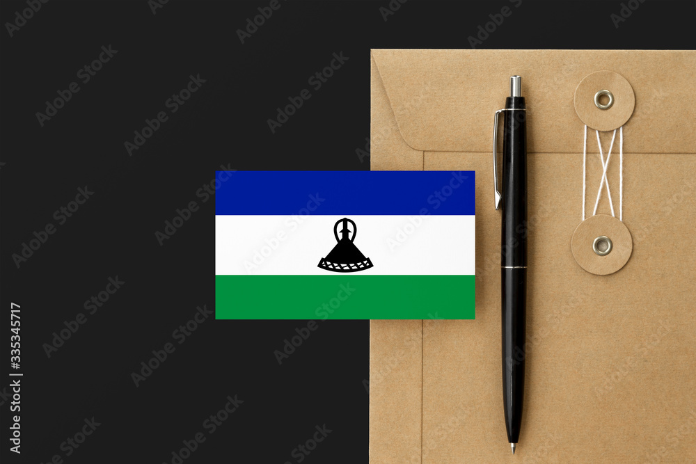 Lesotho flag on craft envelope letter and black pen background ...