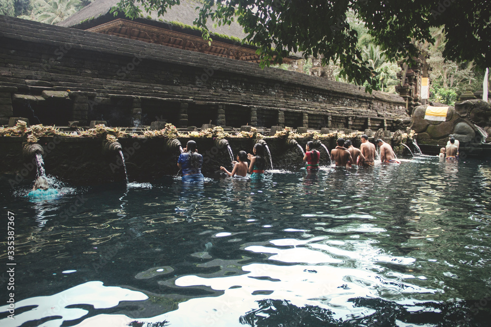 Group of person praying in the holy spring of Tirta Empul, Bali ...