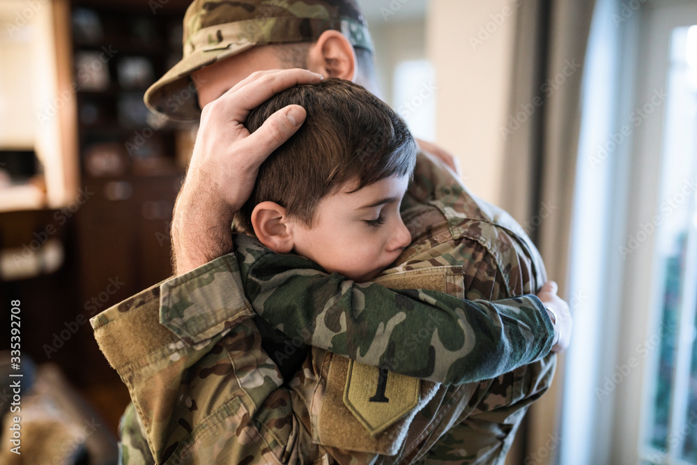 Soldier father holding son tenderly Stock Photo | Adobe Stock