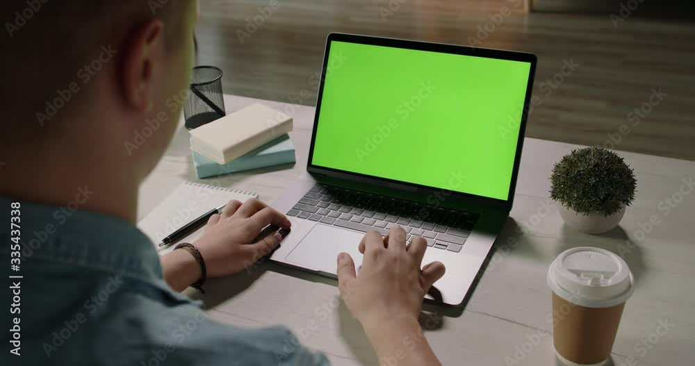 Close up shot of hands of a remote worker working on laptop computer ...