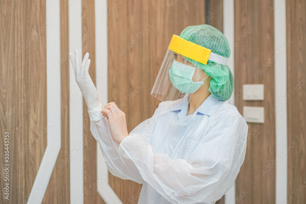 Front-line healthcare workers prepare wearing Personal Protective ...