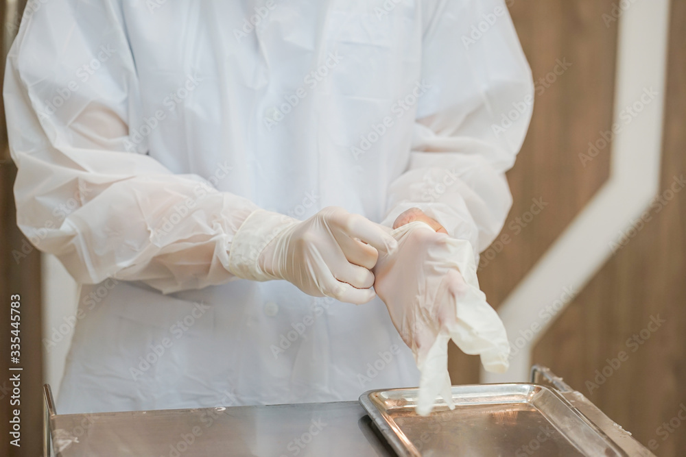Medical staff prepare wearing Personal Protective Equipment (PPE) for ...