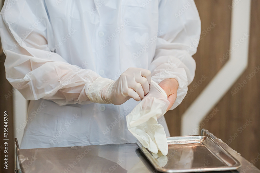 Medical staff prepare wearing Personal Protective Equipment (PPE) for ...