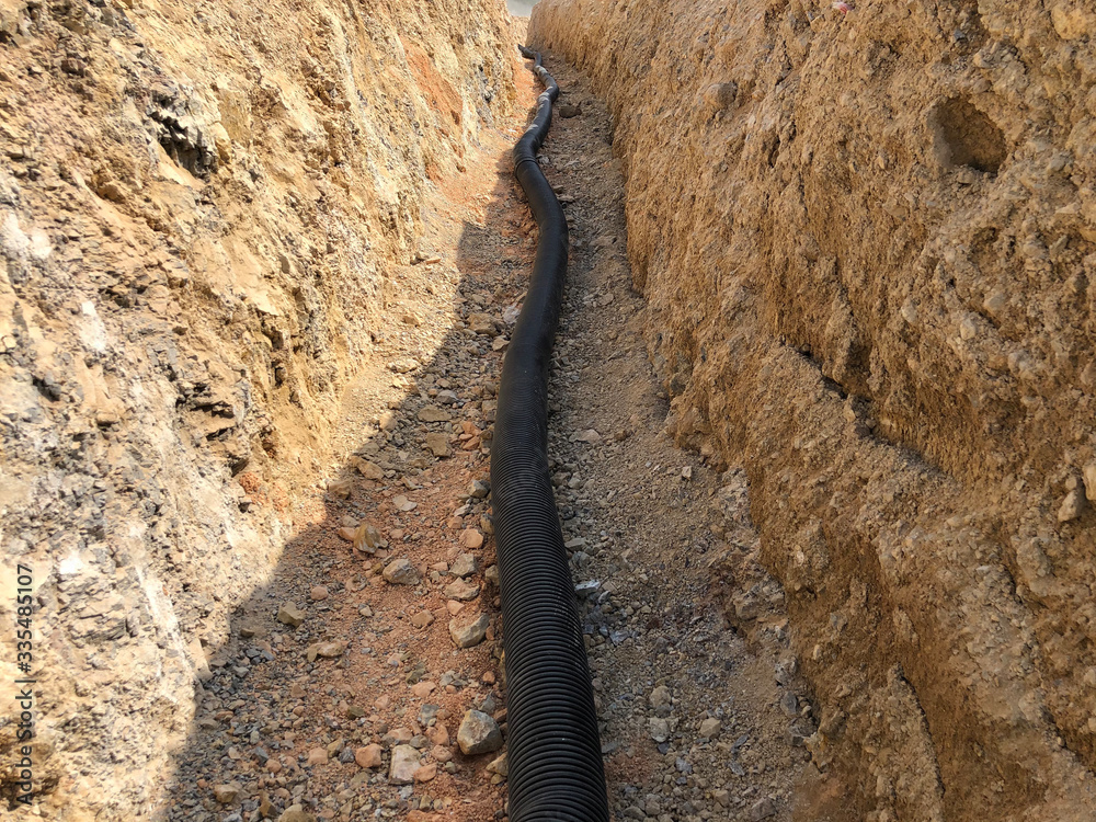 The high voltage electrical cable is laid in a trench Stock Photo ...