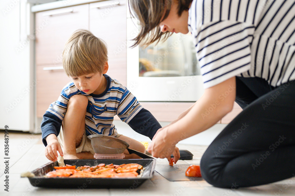 happy family make food at home. mom together her four year old kid son ...