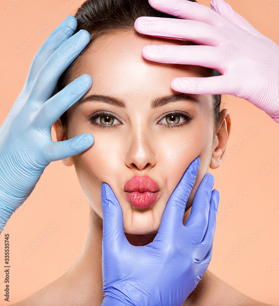 Face skin check before plastic surgery. Beautician touching young woman ...